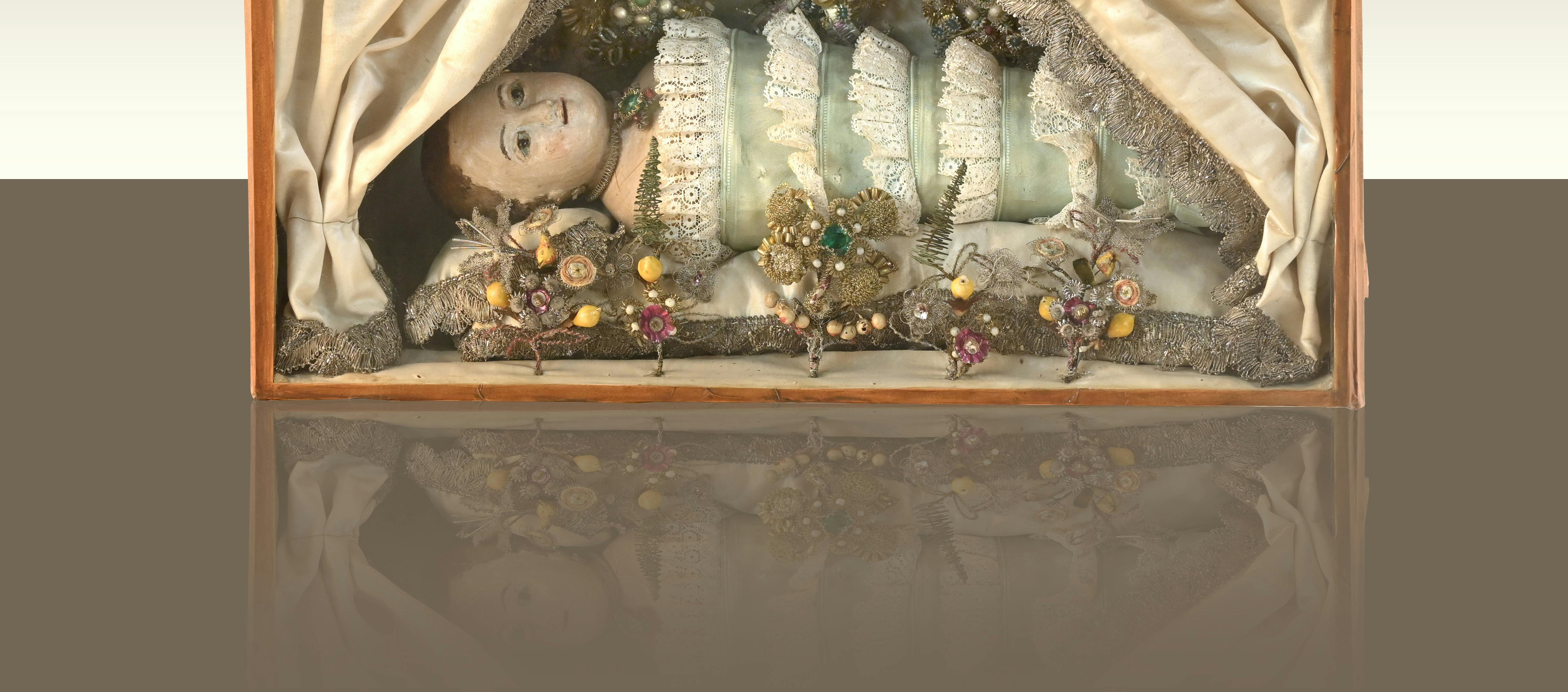 Infant Jesus, wrapped in swaddling clothes and laid in a manger ...